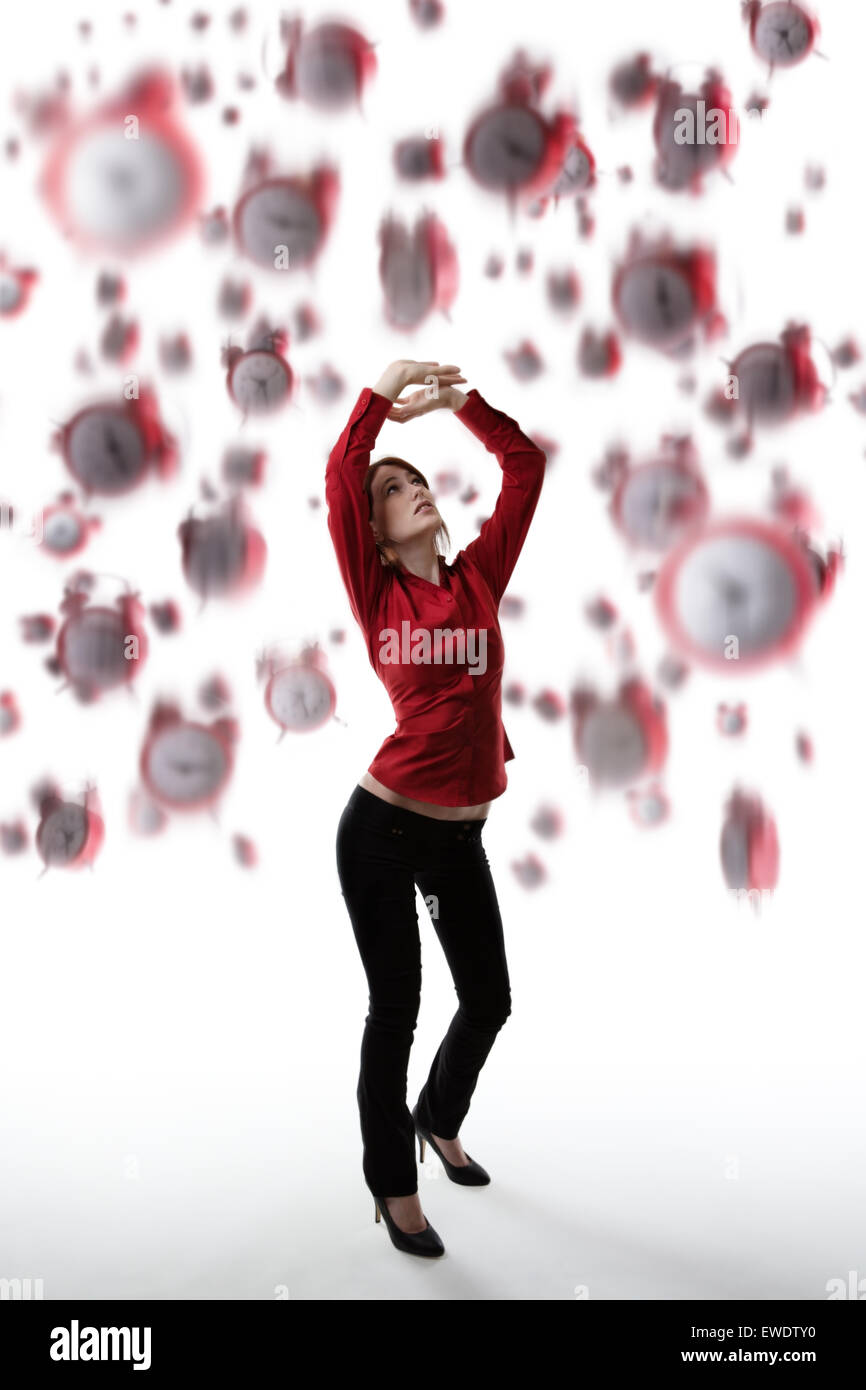 standing woman with arms up above her head protecting her self from ...