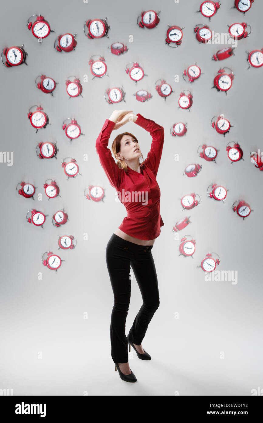 standing woman with arms up above her head protecting her self from ...