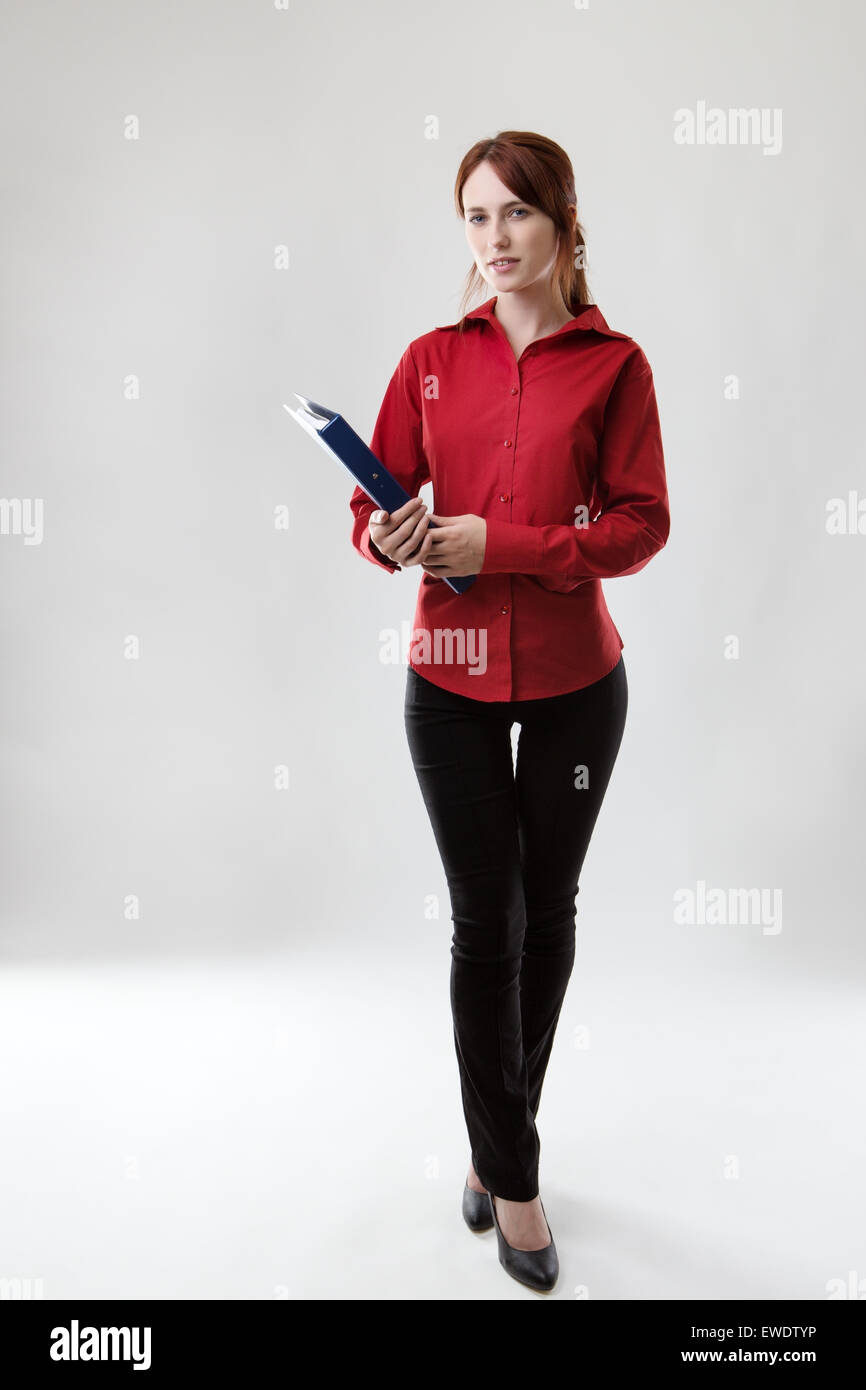 standing business woman holding a folder Stock Photo - Alamy