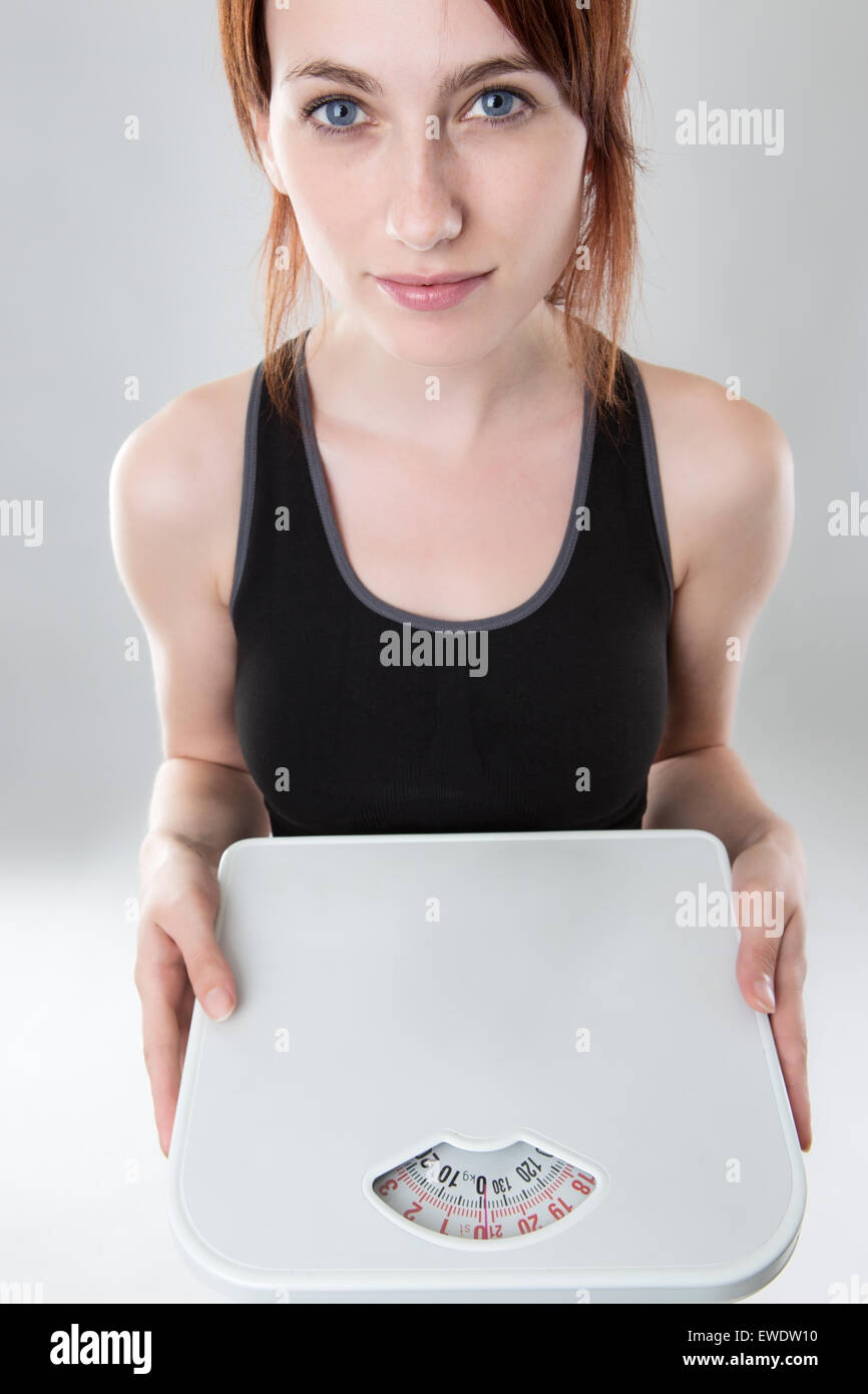 woman holding scales shot from above looking down on midel Stock Photo ...