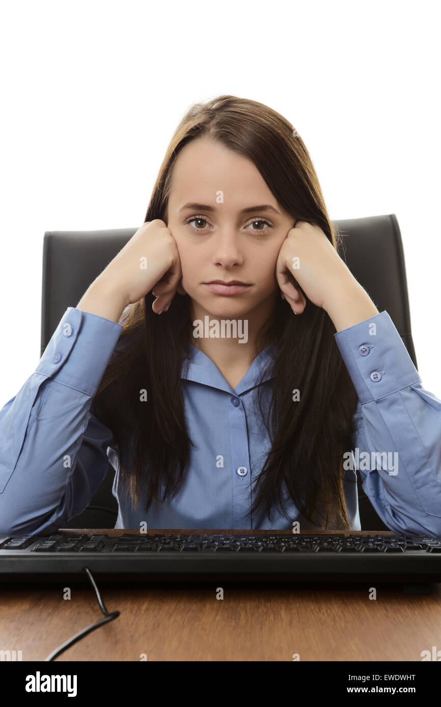 bored business woman with her hands up to her face looking very bored ...