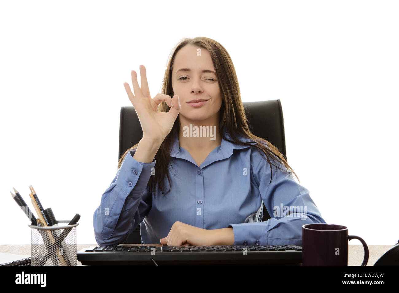 business woman sitting at her desk doing a ok sign with her hand Stock ...