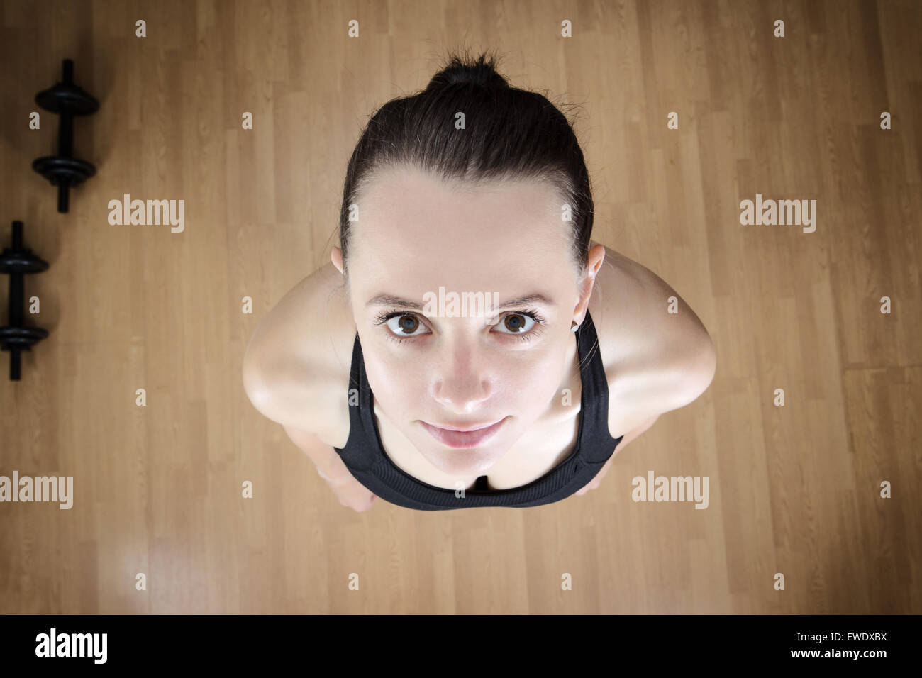 fitness woman looking up at camera at a high view point above the model ...