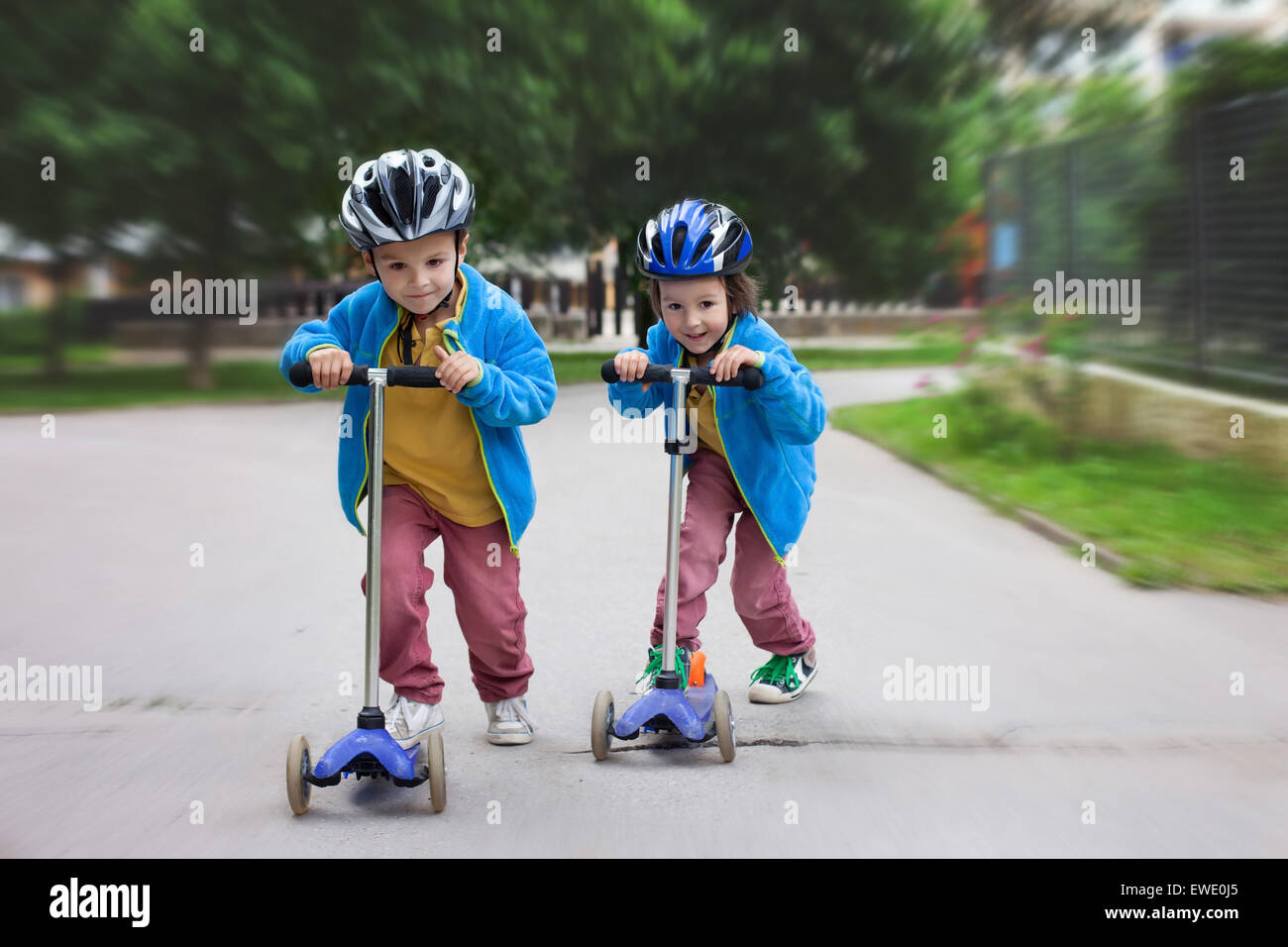 Kids ride scooters hi-res stock photography and images - Alamy
