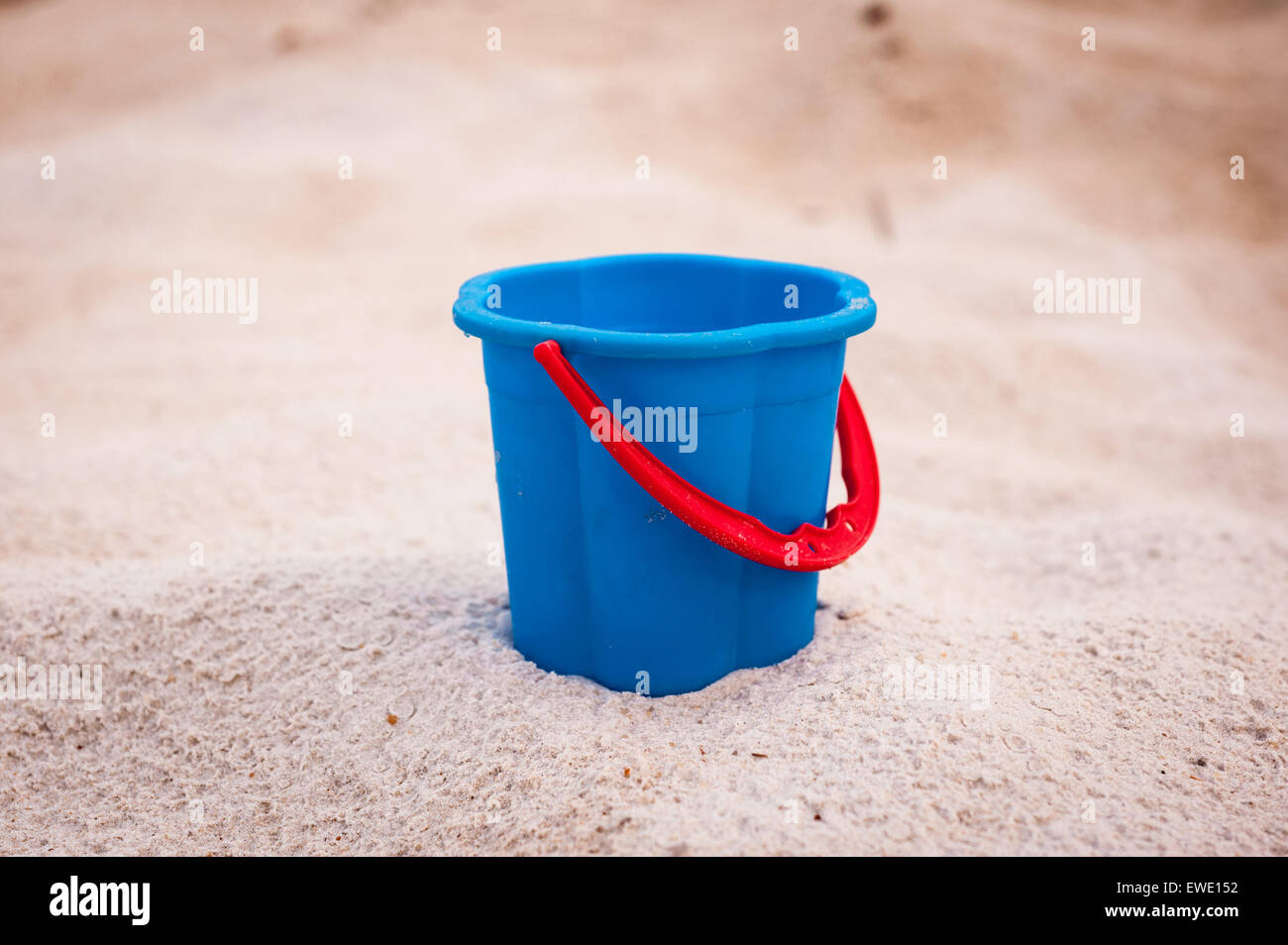 blue empty bucket with red handle, summer, sand Stock Photo - Alamy