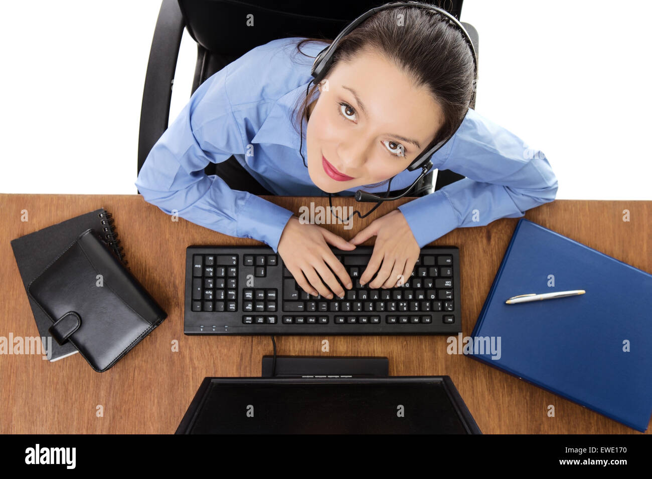 woman working at a desk wearing a head set shot from above Stock Photo ...