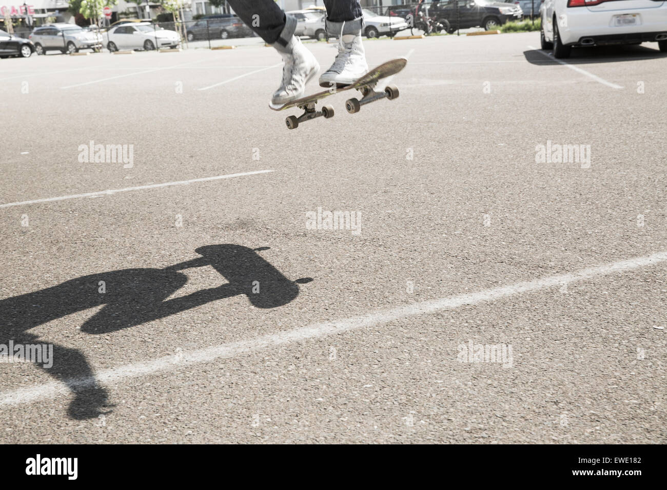 Young man skateboarding in a car park urban city life Stock Photo - Alamy