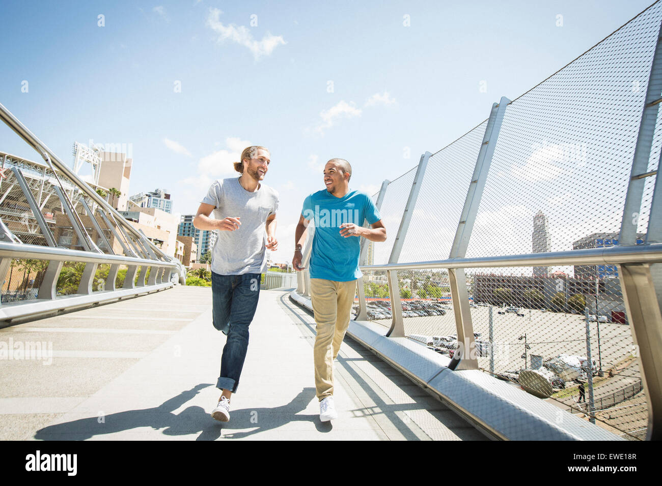 Two young men jogging along footbridge Stock Photo - Alamy Two young men jogging along footbridge Stock Photo - Alamy