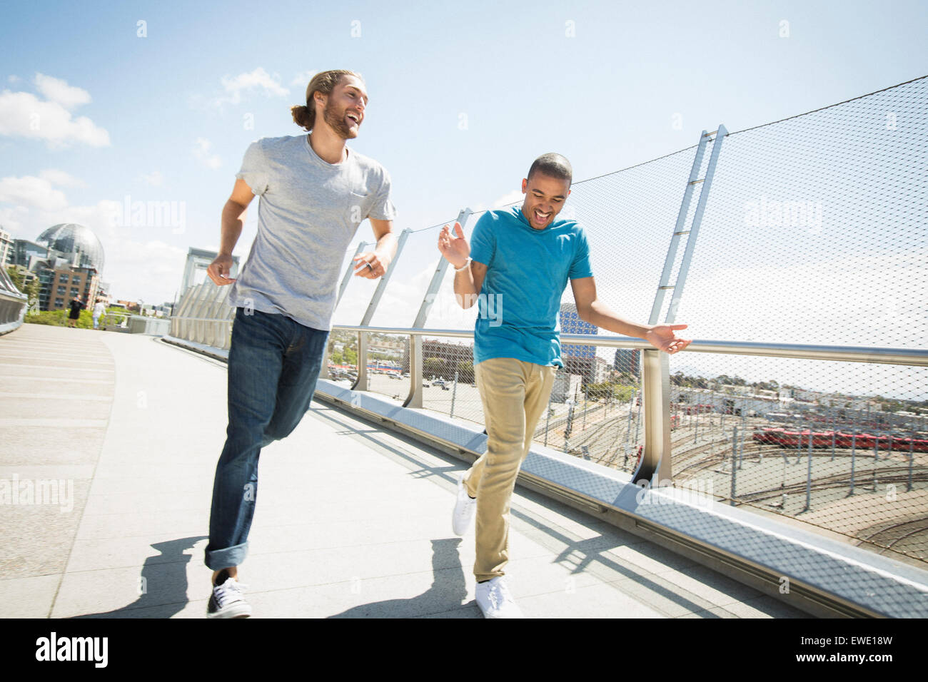 Two young men jogging along footbridge Stock Photo - Alamy Two young men jogging along footbridge Stock Photo - Alamy