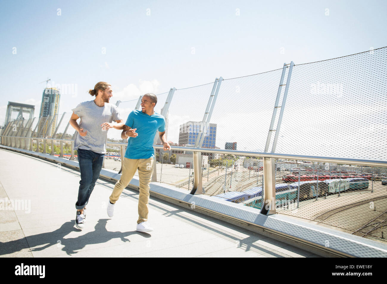 Two young men jogging along footbridge Stock Photo - Alamy Two young men jogging along footbridge Stock Photo - Alamy
