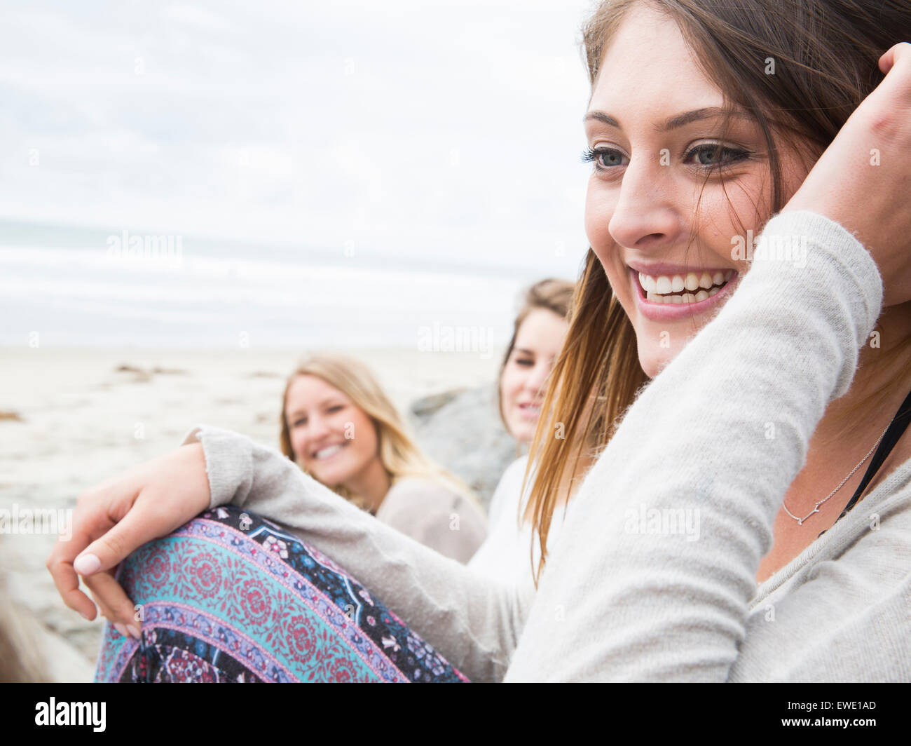 Female sitting on beach hi-res stock photography and images - Alamy