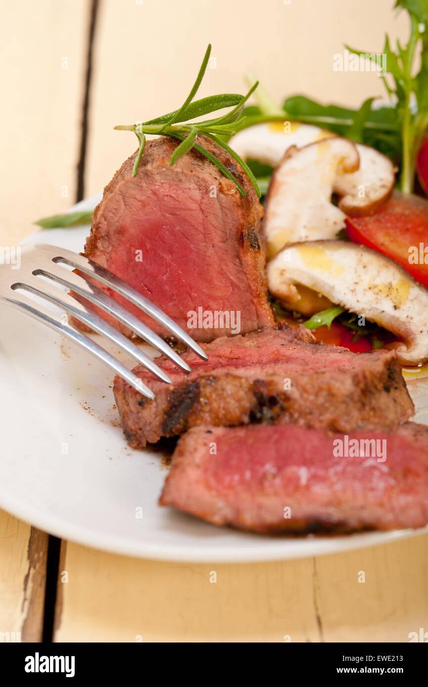 beef filet mignon grilled with fresh vegetables on side ,mushrooms tomato and arugula salad ...