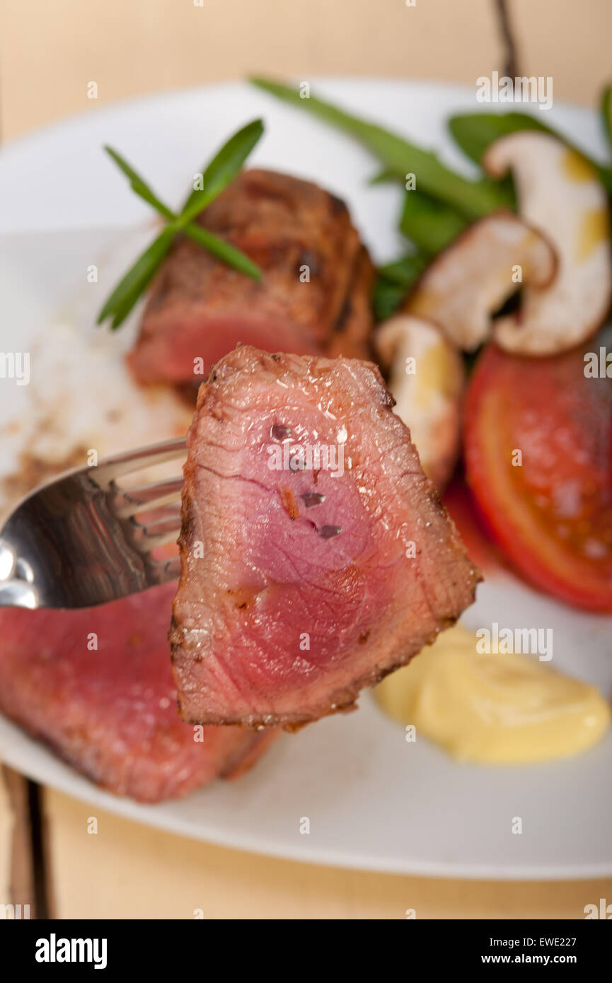 beef filet mignon grilled with fresh vegetables on side ,mushrooms tomato and arugula salad ...