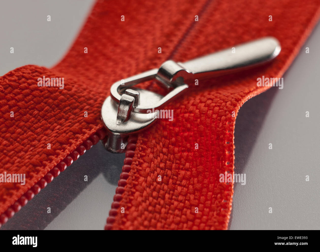a red zipper opened to a gray surface Stock Photo - Alamy