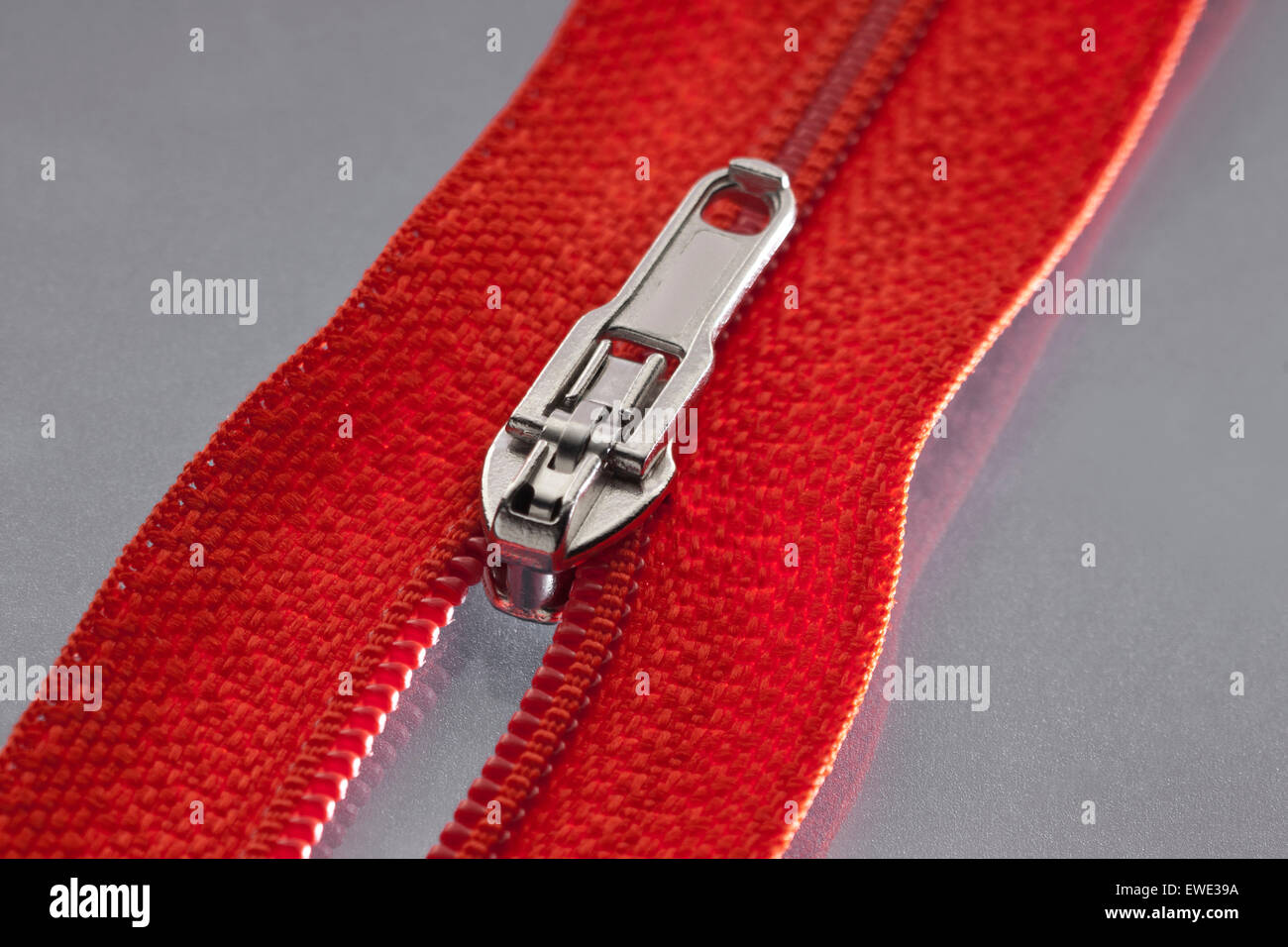 a red zipper opened to a gray surface Stock Photo - Alamy
