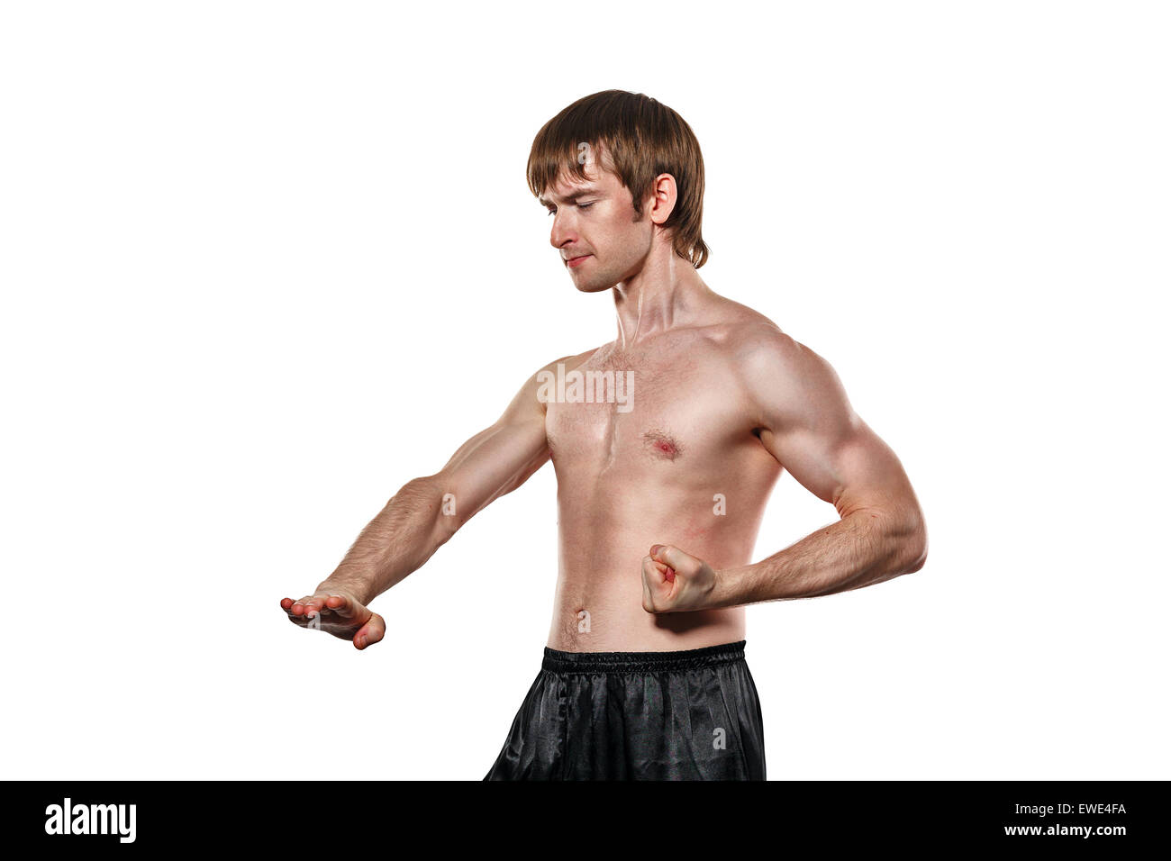 The man trains kata kung fu block lower kick. Isolated on white ...
