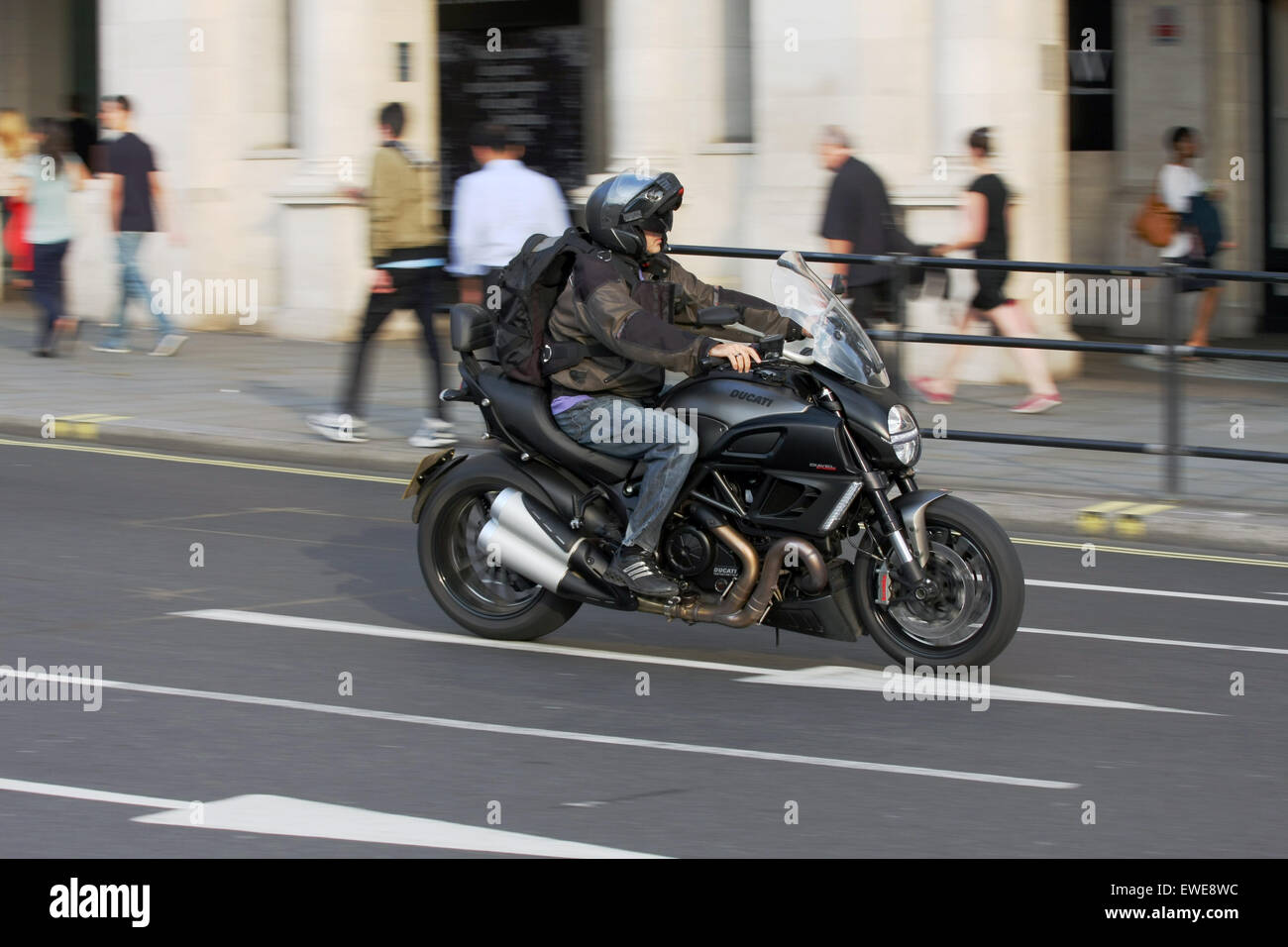 A biker riding a motorbike towards Trafalgar Square in London, England ...