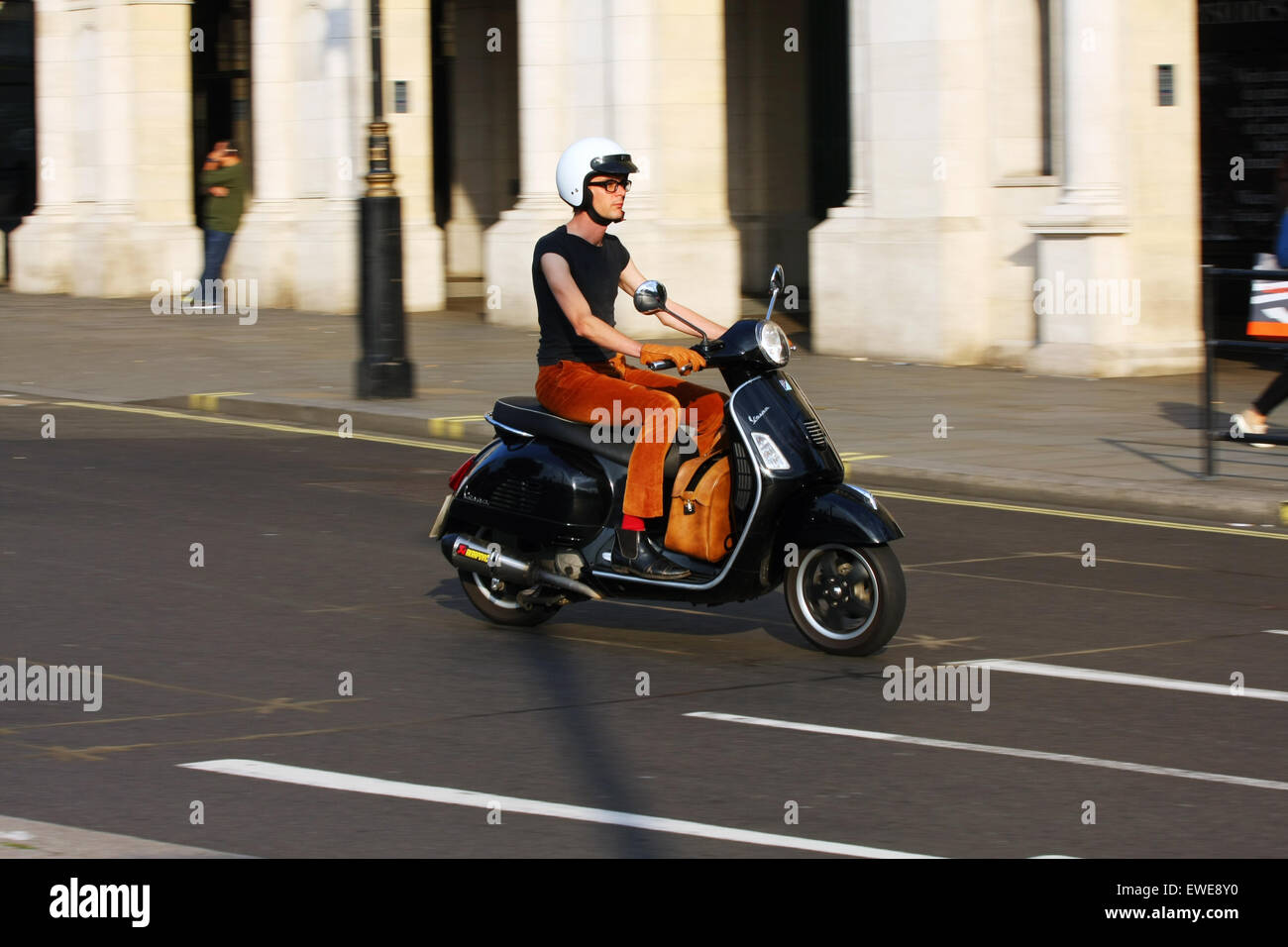 A male riding a motor scooter in London, England Stock Photo - Alamy