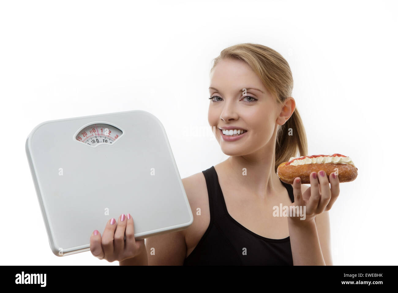 woman holding scale and a cream cake Stock Photo - Alamy