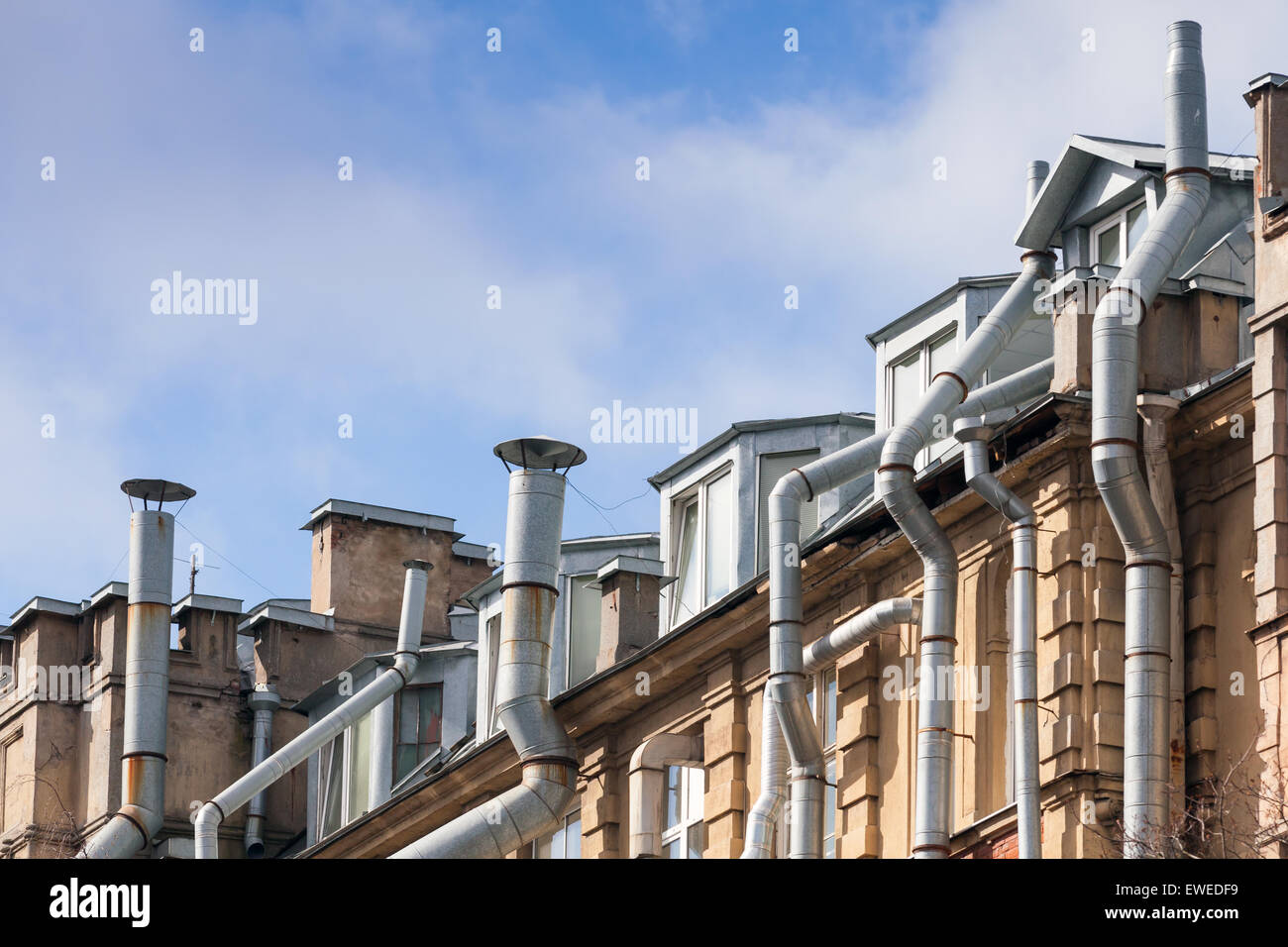 New attic windows in old living house roof with ventilation pipes, high ...