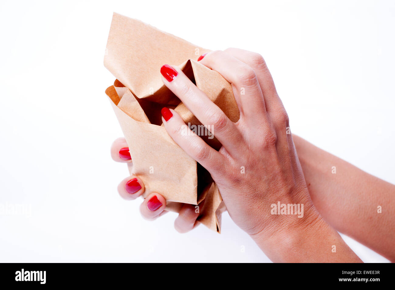 Female hands holding a crumpled paper, white background Stock Photo - Alamy