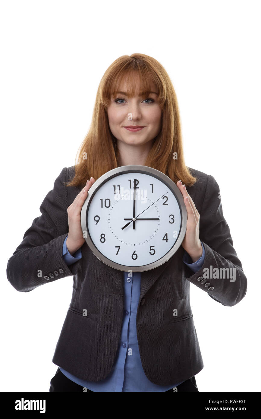 businesswoman wearing a suit holding a wall clock up to her chest Stock ...