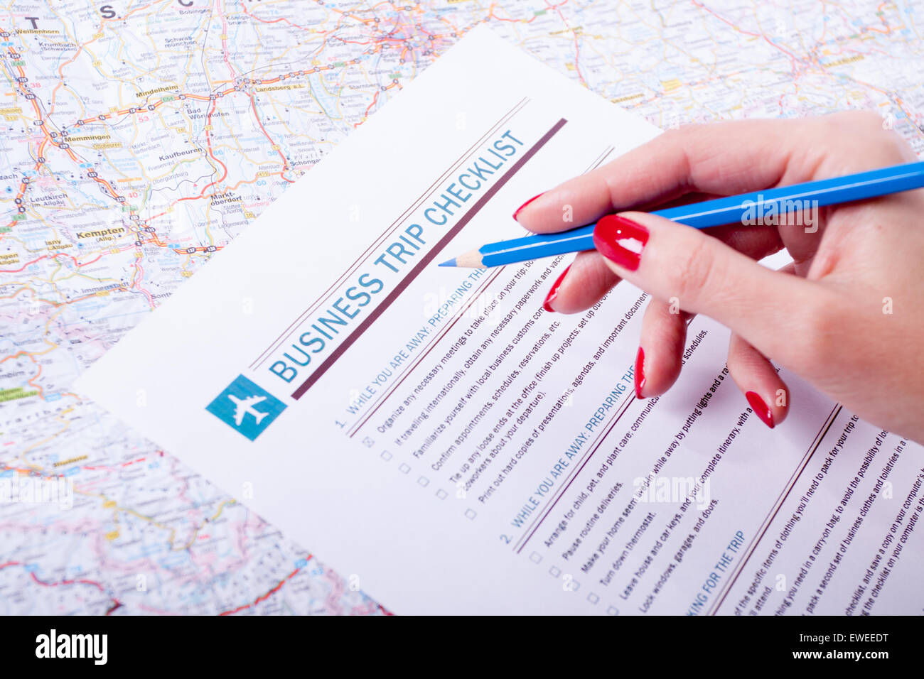Business trip check list, woman holding blue pencil Stock Photo - Alamy