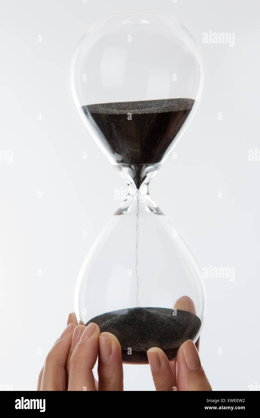 Female hands holding hourglass hi-res stock photography and images - Alamy