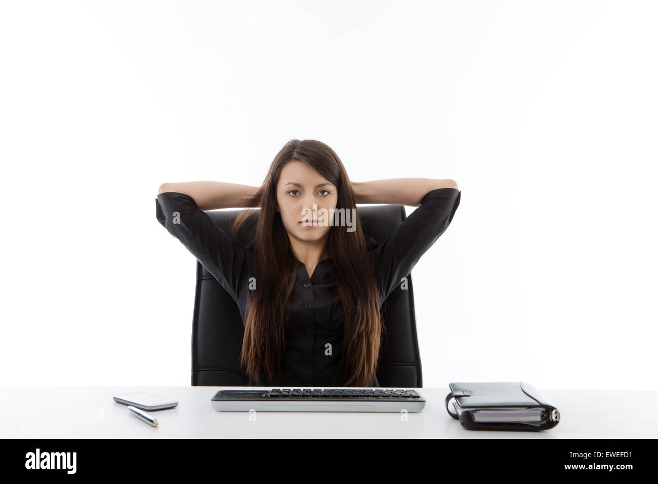 office worker sitting at her desk relaxing with her arms up Stock Photo ...