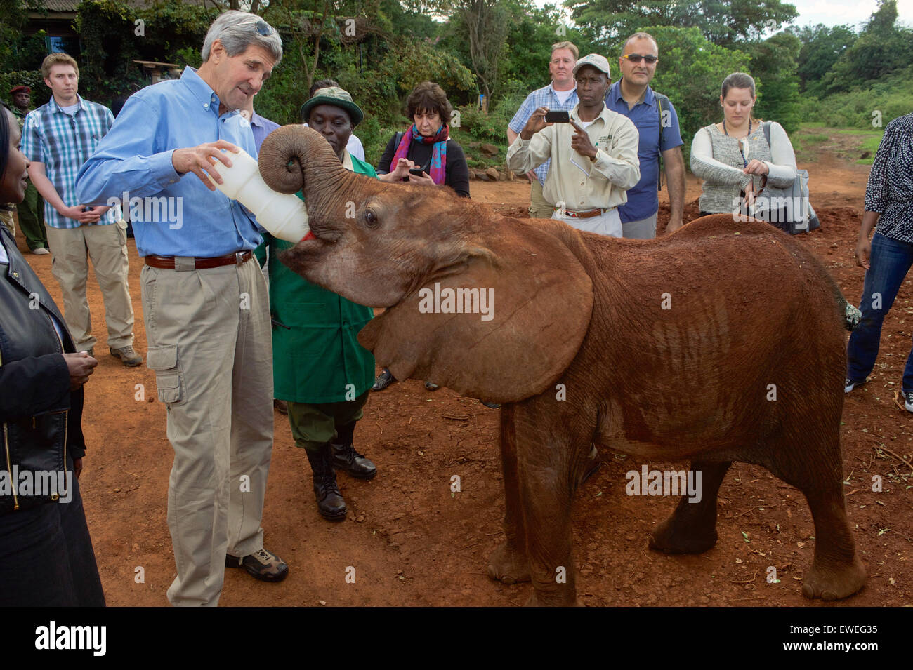 U.S. Secretary of State John Kerry feeds a baby elephant at the ...