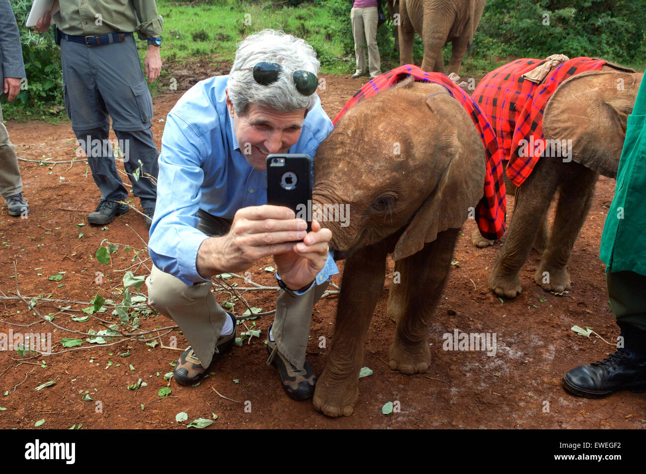 U.S. Secretary of State John Kerry poses for a photo with a baby ...