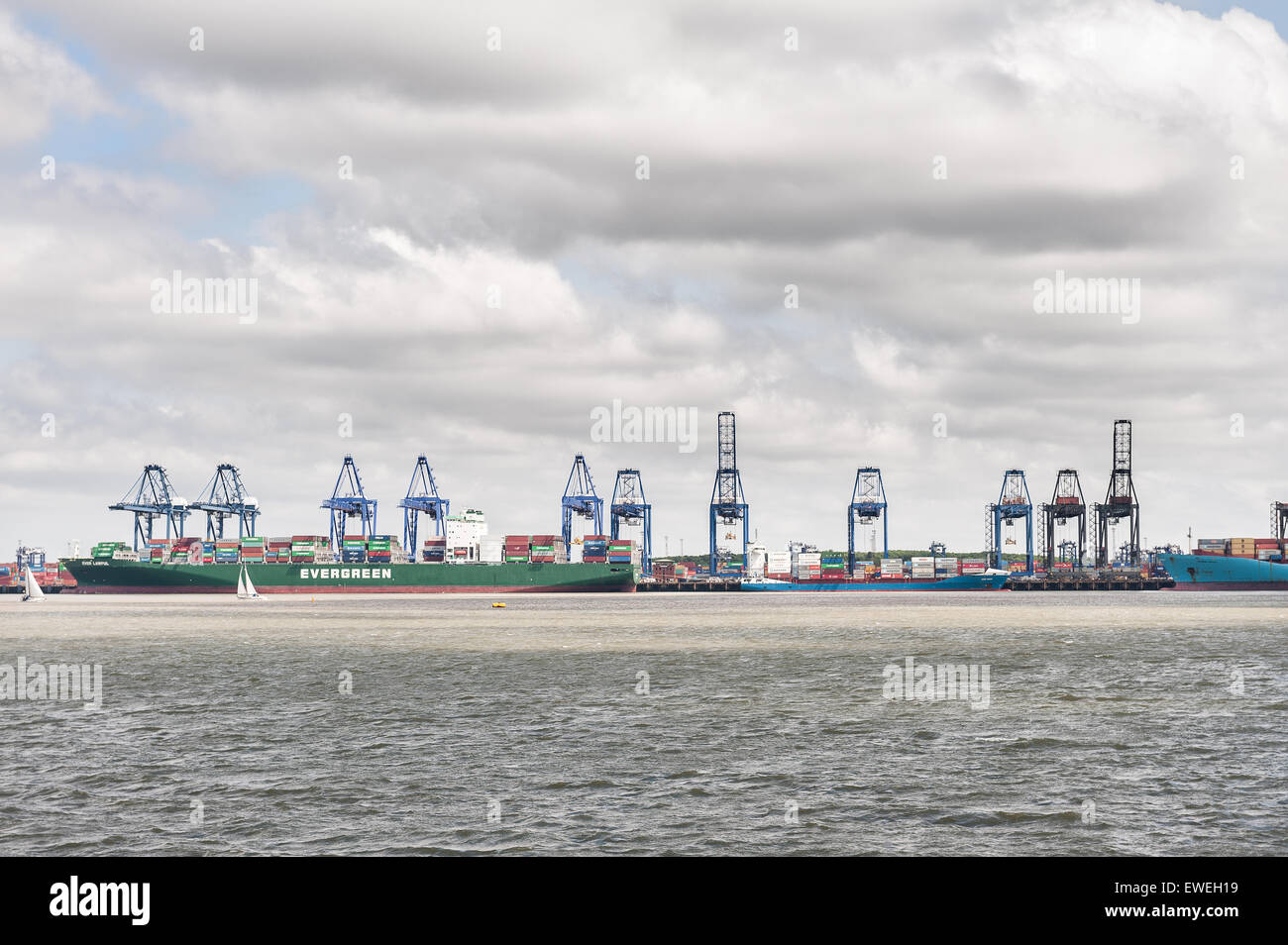 Felixstowe shipping port docks with massive cranes loading large ...