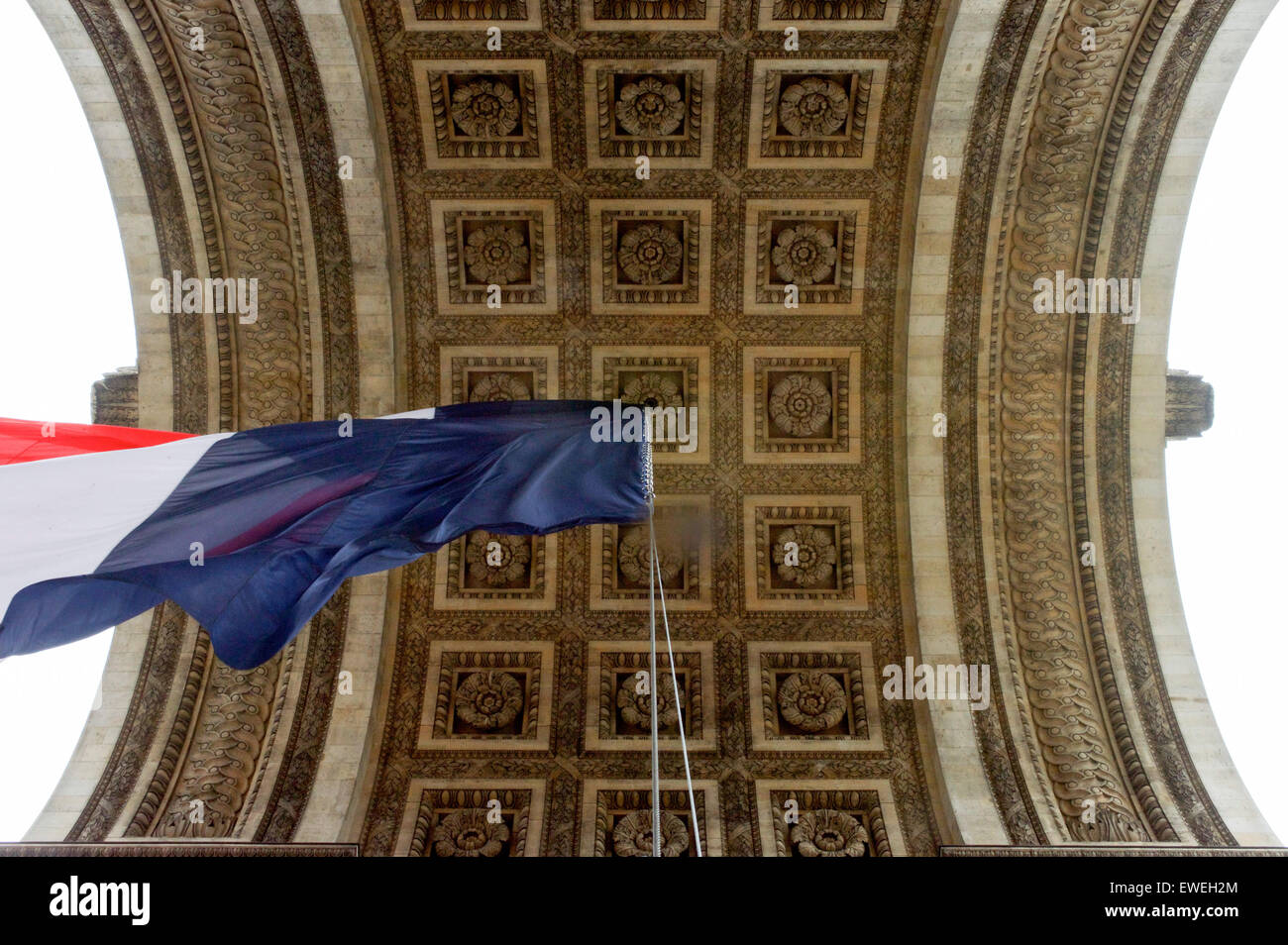 French tri-color flag flies in the span of Arc d'Triomphe, before U.S ...