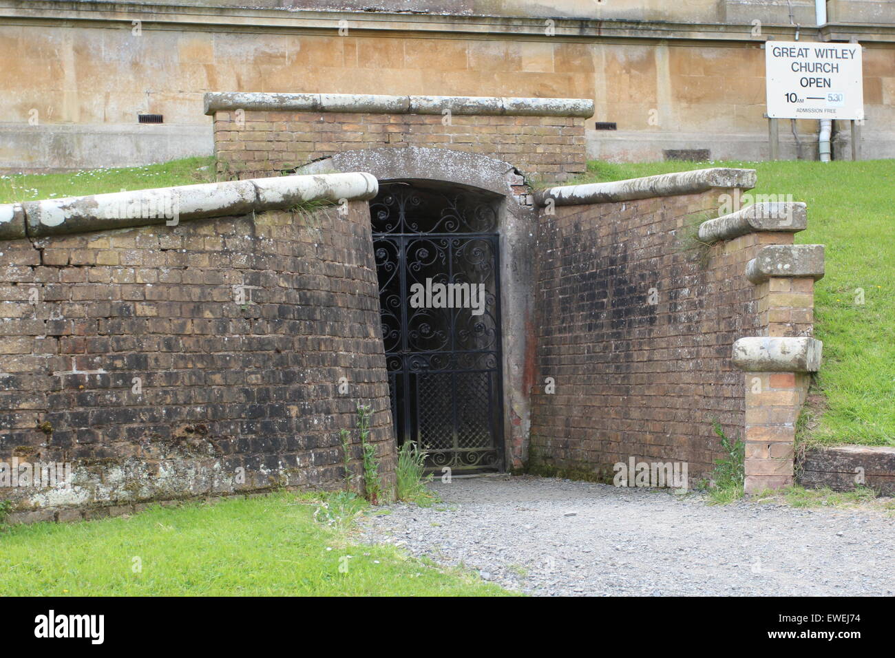 Church Crypt entry iron Gate and Stone and Brick wall Stock Photo - Alamy