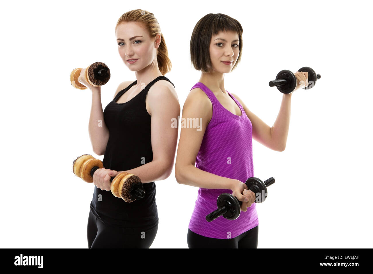 two fitness model standing back to back both are weight training with ...