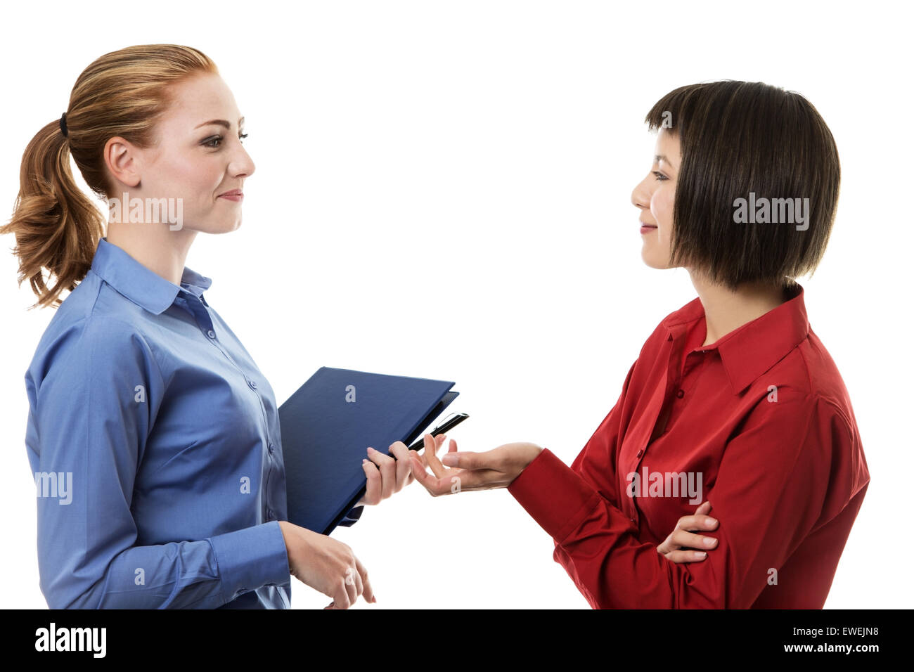 Two business woman chatting away together Stock Photo - Alamy