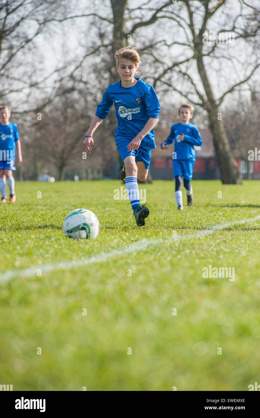 A young boy plays football in London for his local team Stock Photo - Alamy