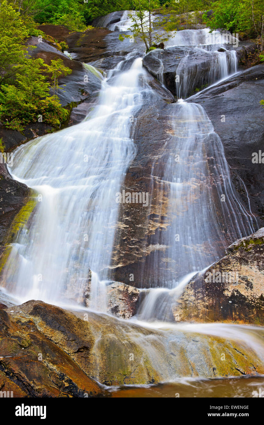 Noname waterfall running down on the hard rock of a mountain right into ...