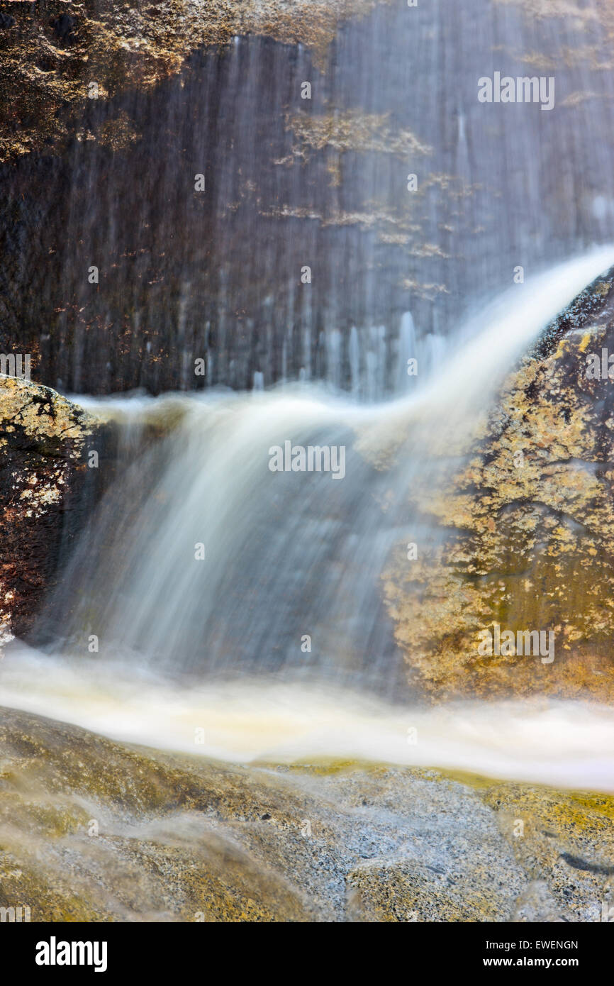 Noname waterfall running down on the hard rock of a mountain right into ...