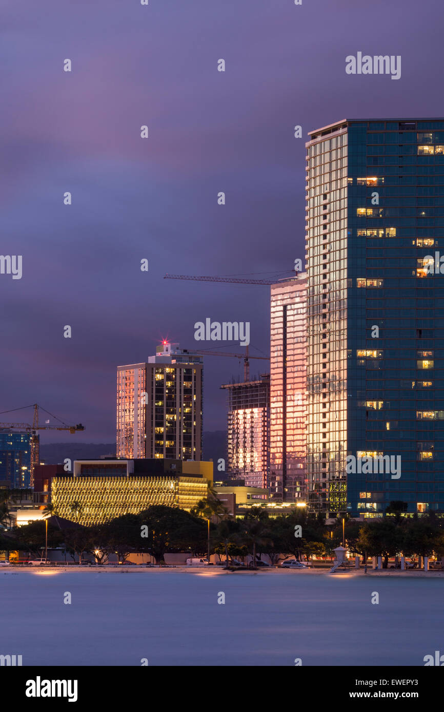 A view of buildings around Ala Moana beach park at dusk in Honolulu ...
