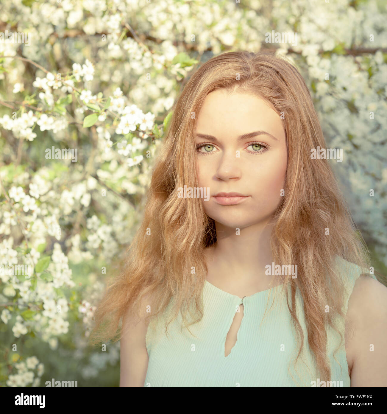 Beautiful girl in the spring blooming garden Stock Photo - Alamy