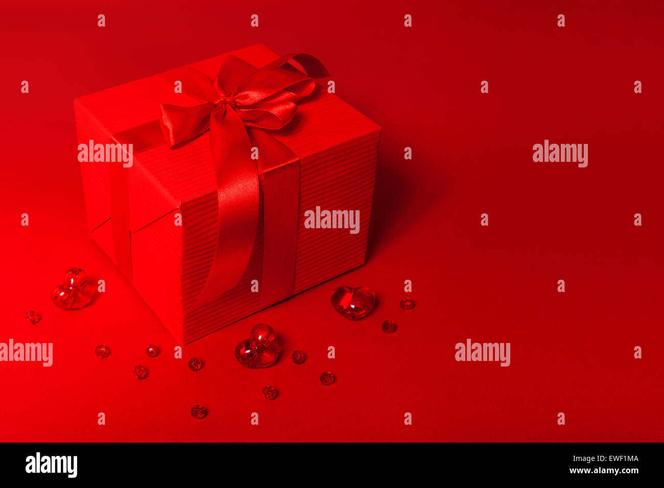 Cute red gift box on the red background Stock Photo - Alamy