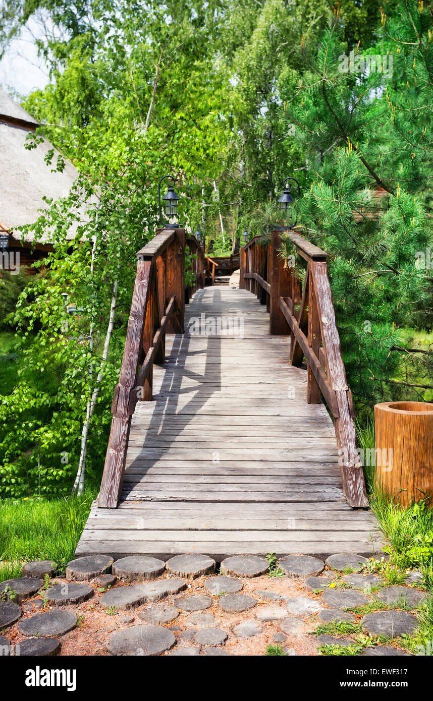 Wooden bridge over the ravine among the trees and pines Stock Photo - Alamy