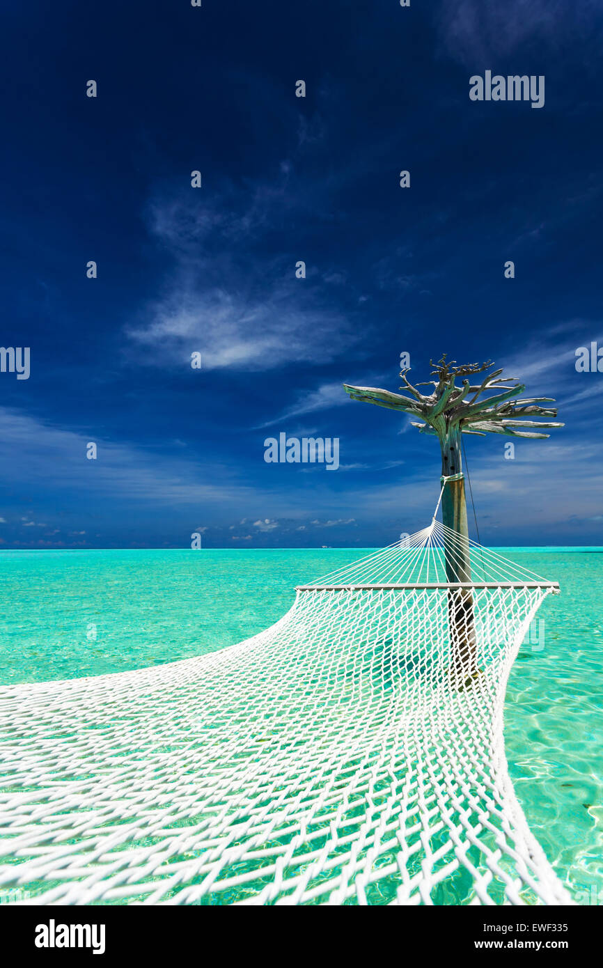 Empty over-water hammock in the middle of tropical lagoon in Maldives ...
