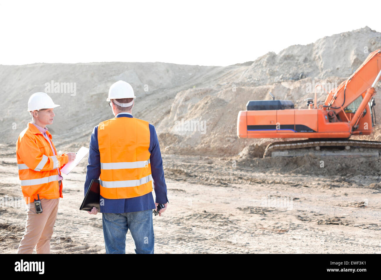 Supervisors standing at construction site against clear sky Stock Photo ...