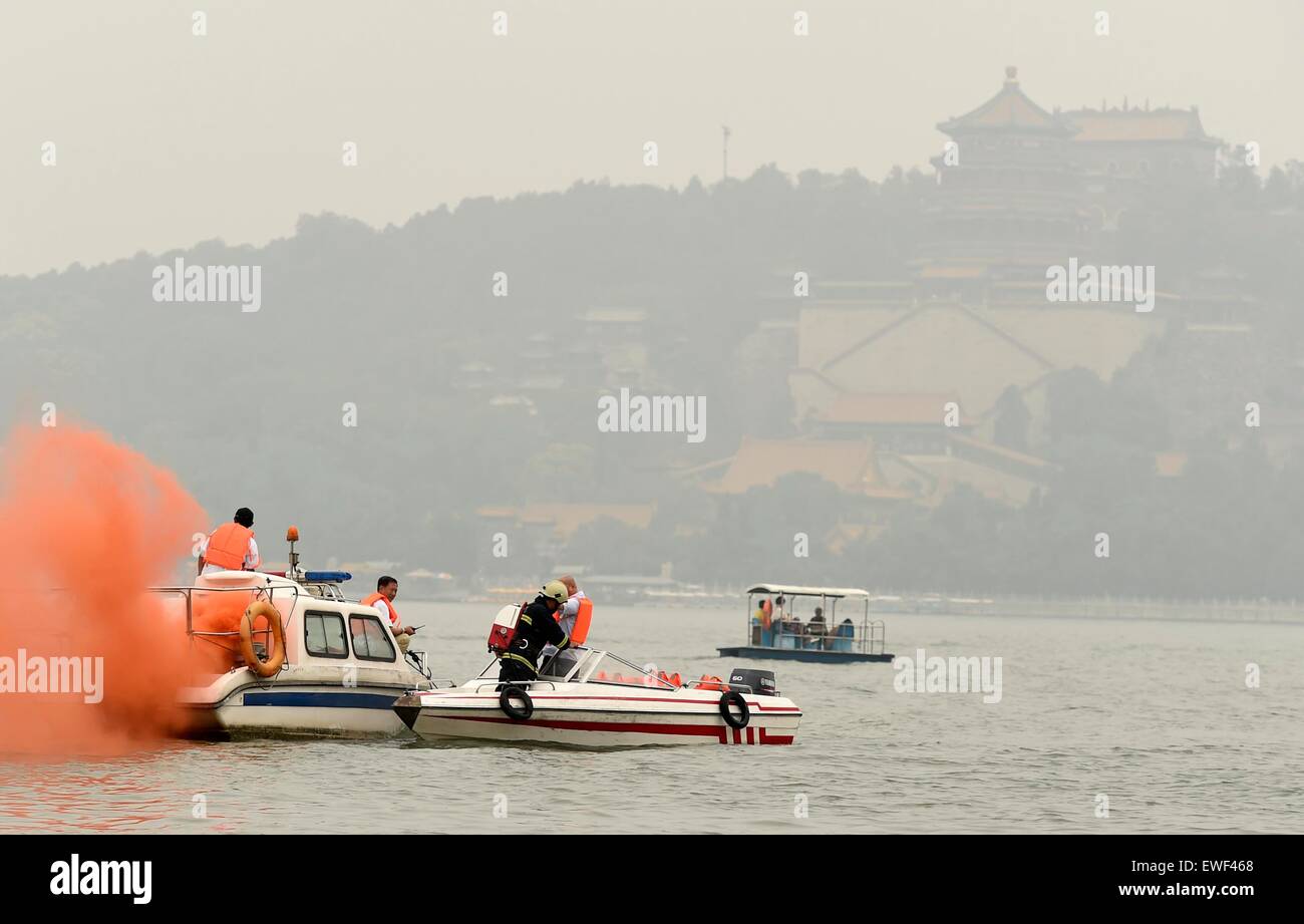 Beijing, China. 25th June, 2015. Workers and firefighters deal with ...