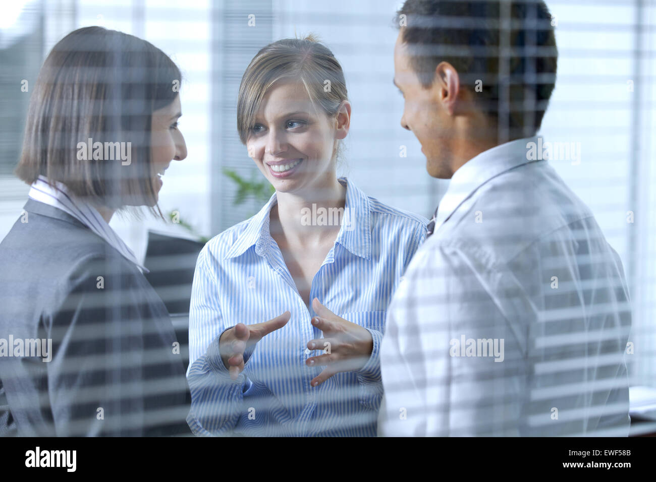 Business people conversing in office Stock Photo - Alamy