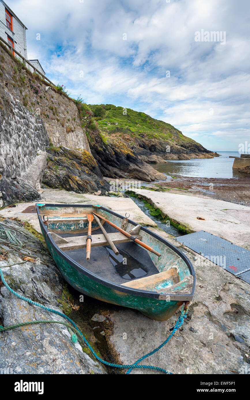 An old boat on the beach at Portloe on the Roseland Penisnsula in ...