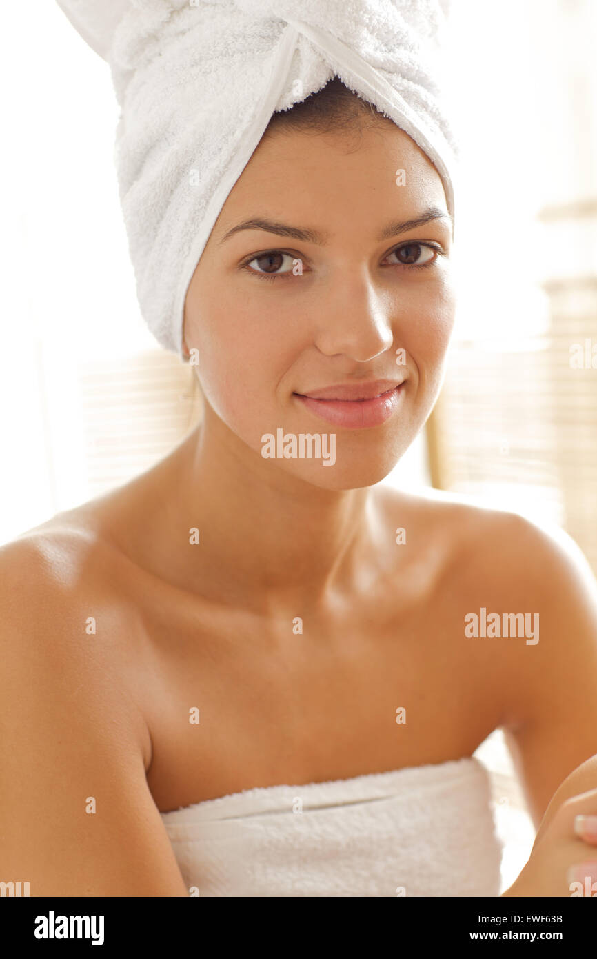 Portrait of young woman wrapped in towel Stock Photo - Alamy