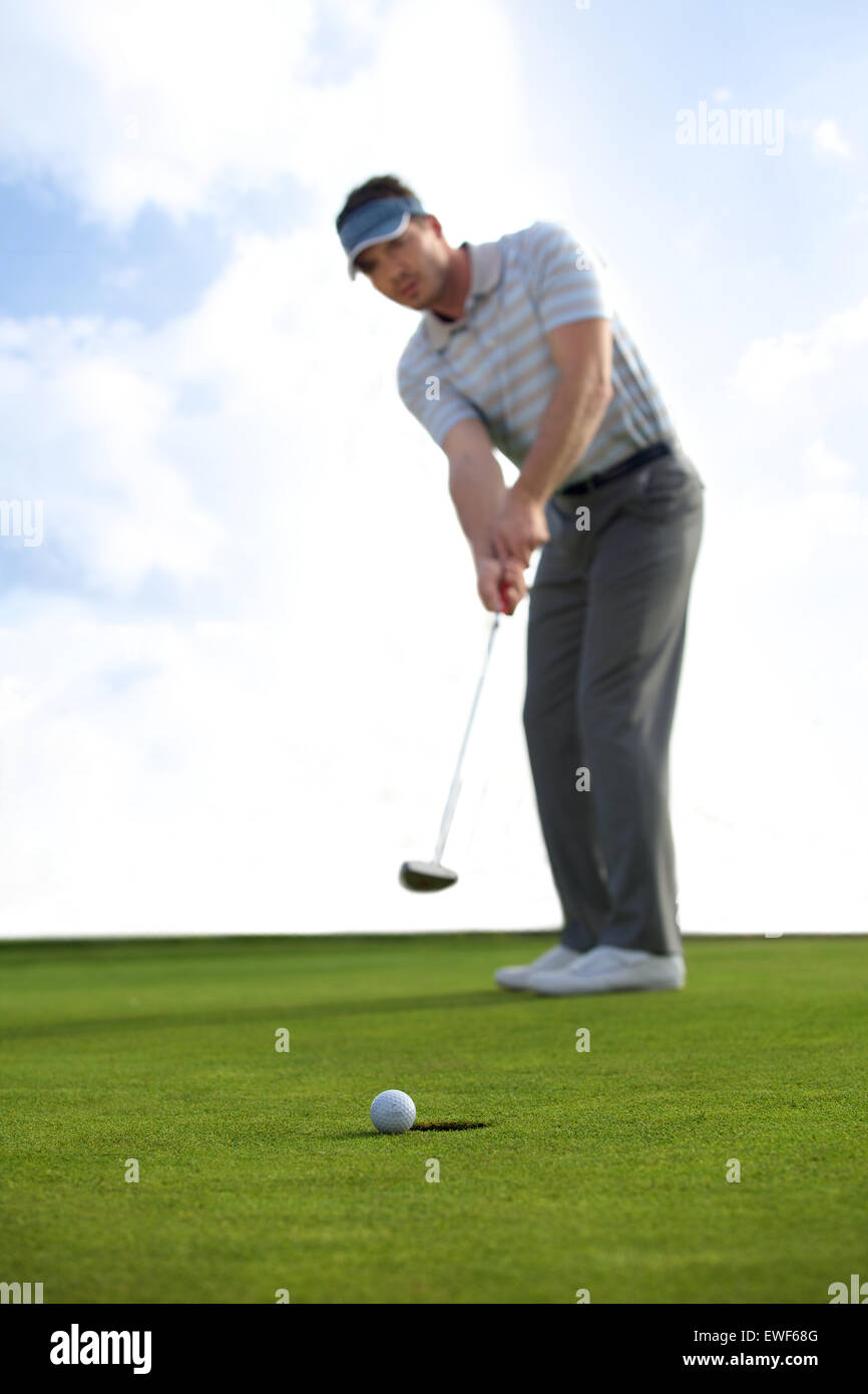 Young man playing golf Stock Photo - Alamy
